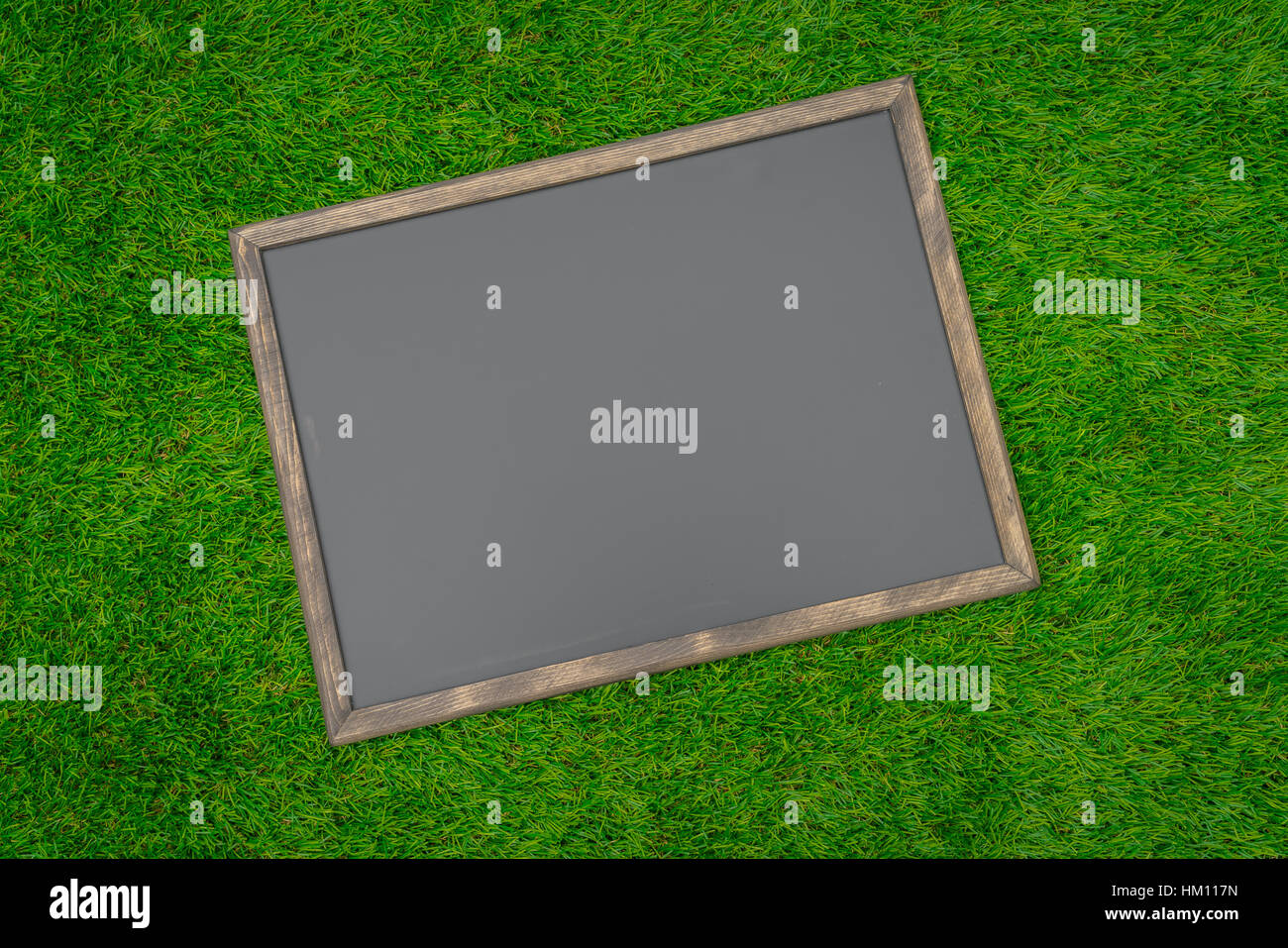 Blank black board on grass field Stock Photo - Alamy