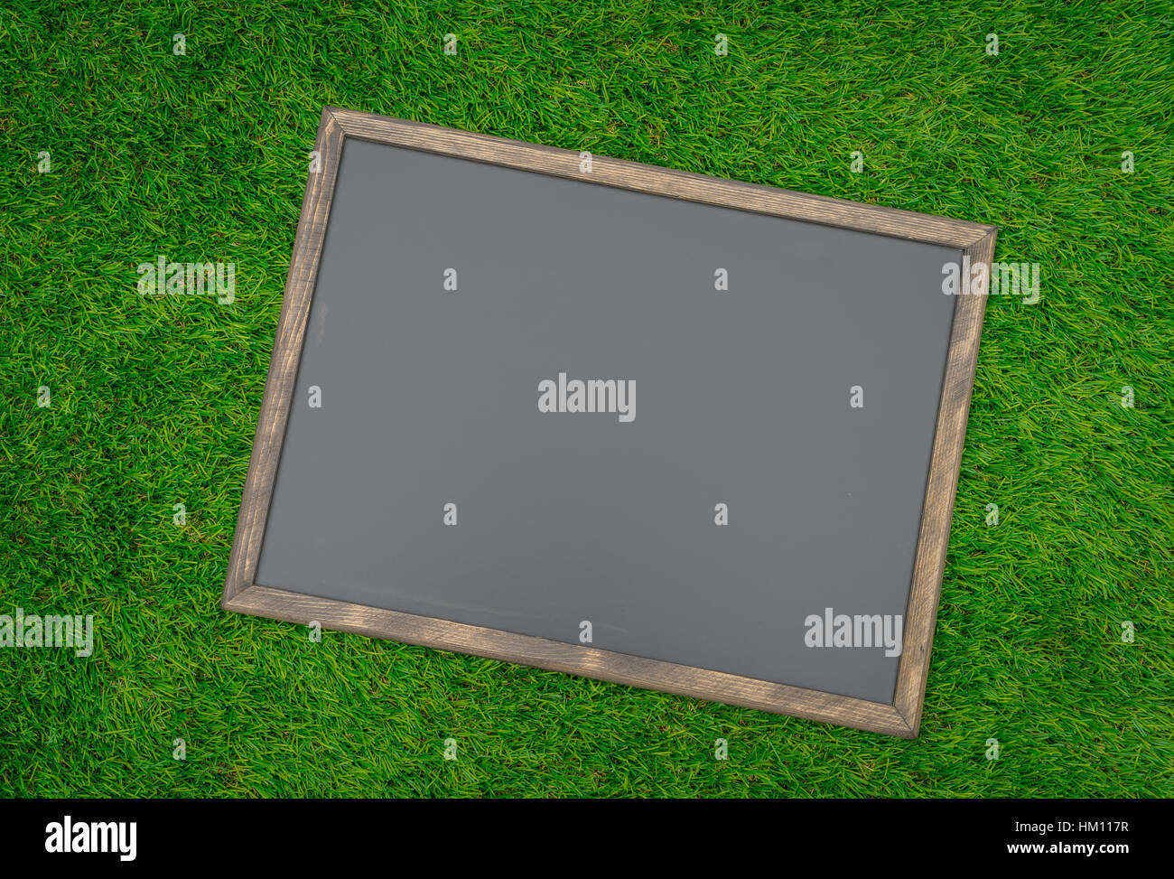 Blank black board on grass field Stock Photo - Alamy