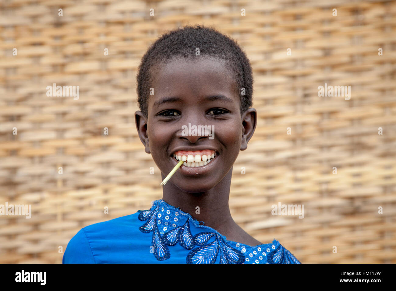 Boy cleaning his teeth with chewing twig Stock Photo - Alamy
