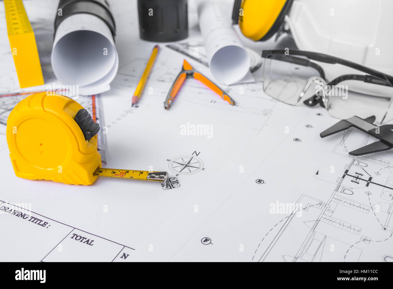 Construction plans with White helmet and drawing tools on blueprints ...