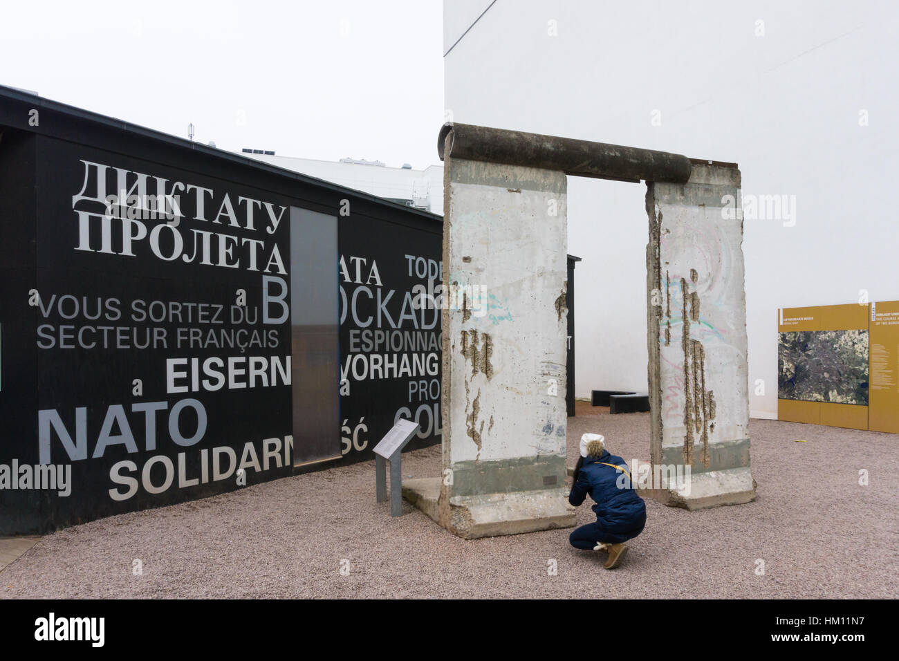A woman takes a photo of a section of the berlin wall at the BlackBox ...