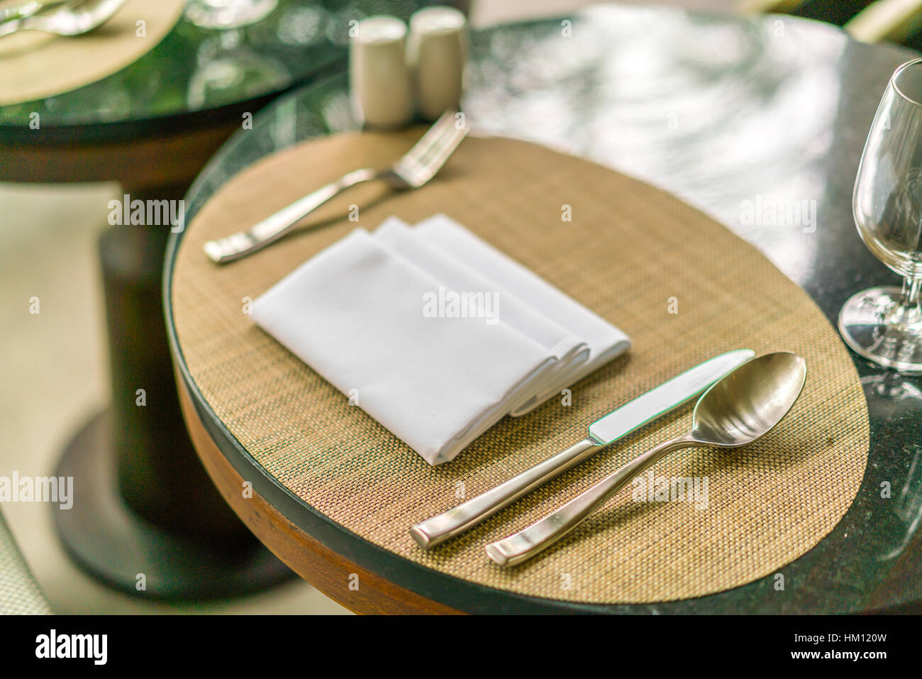 Table appointments- fork,knife,spoon, silk napkin on bamboo mat Stock ...