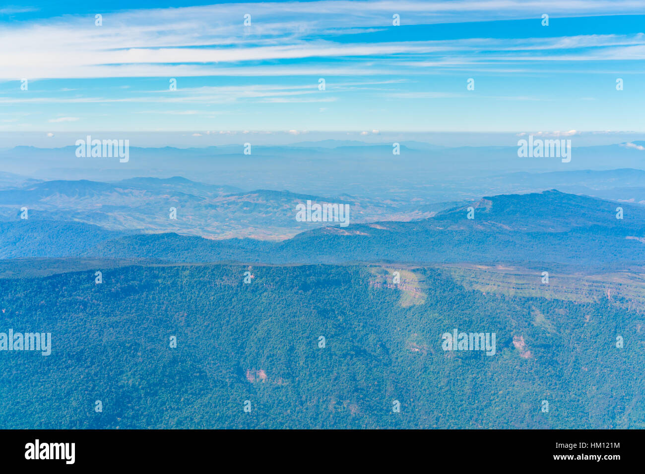 Mountains under clouds. View from the airplane Stock Photo - Alamy