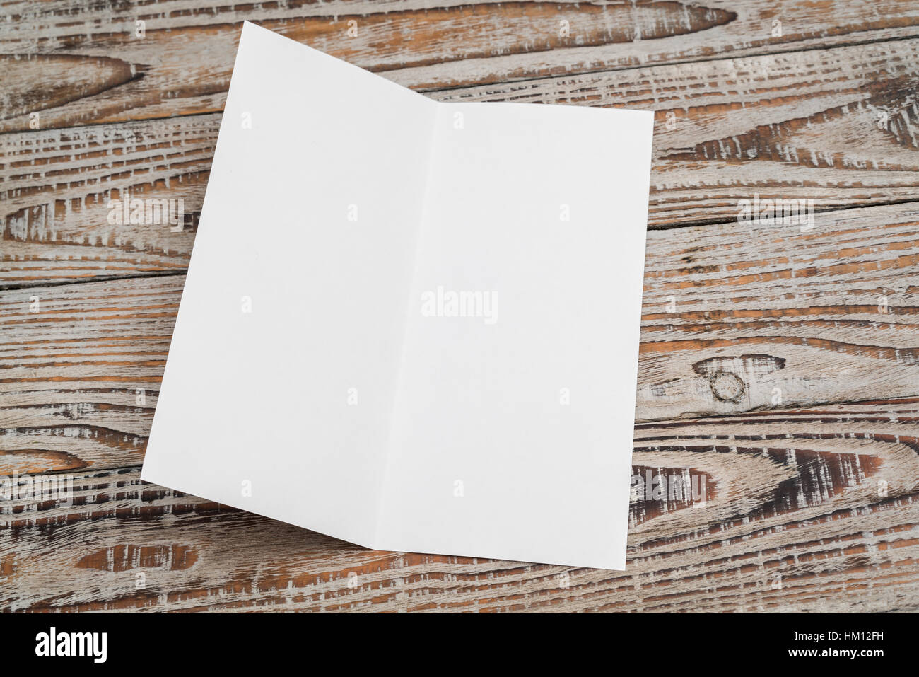 Bifold white template paper on wood texture Stock Photo - Alamy