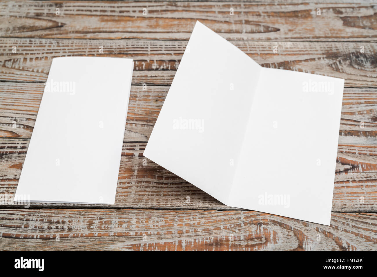Bifold white template paper on wood texture Stock Photo - Alamy
