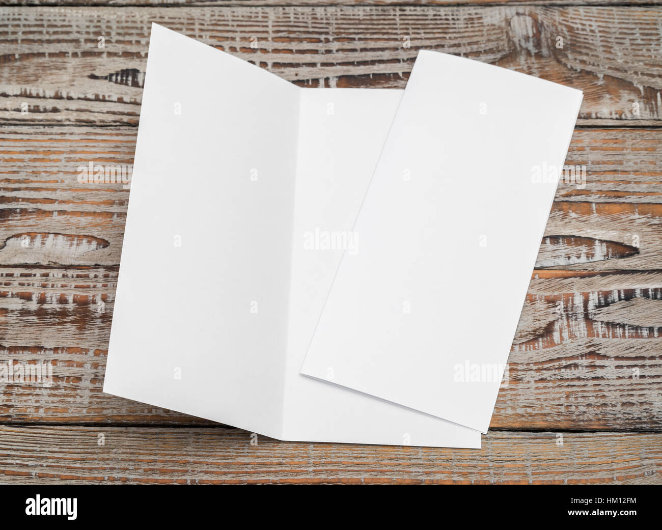 Bifold white template paper on wood texture Stock Photo - Alamy
