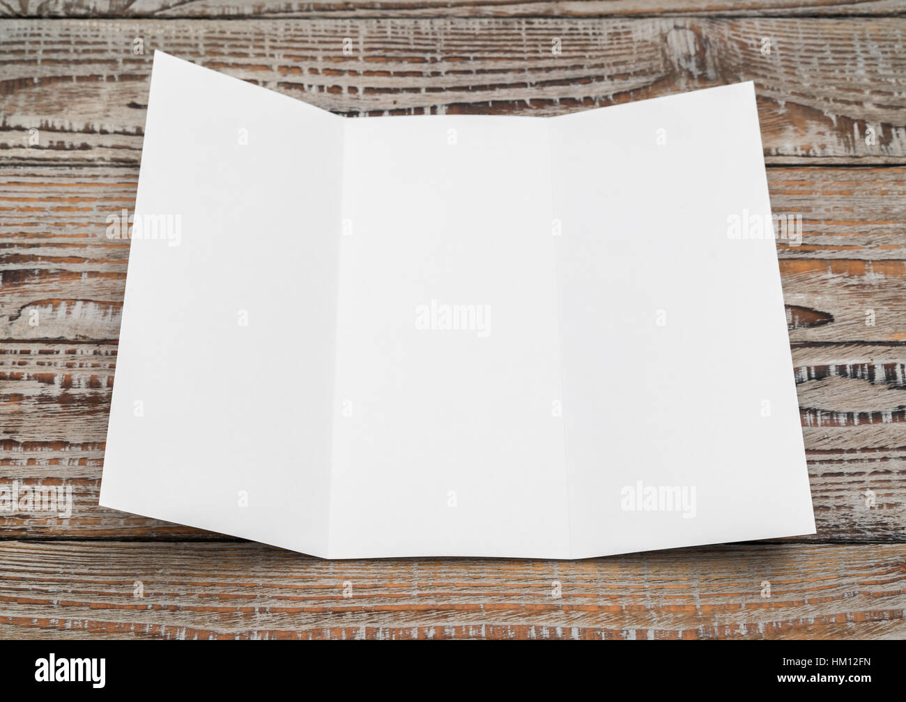 Trifold white template paper on wood texture Stock Photo - Alamy