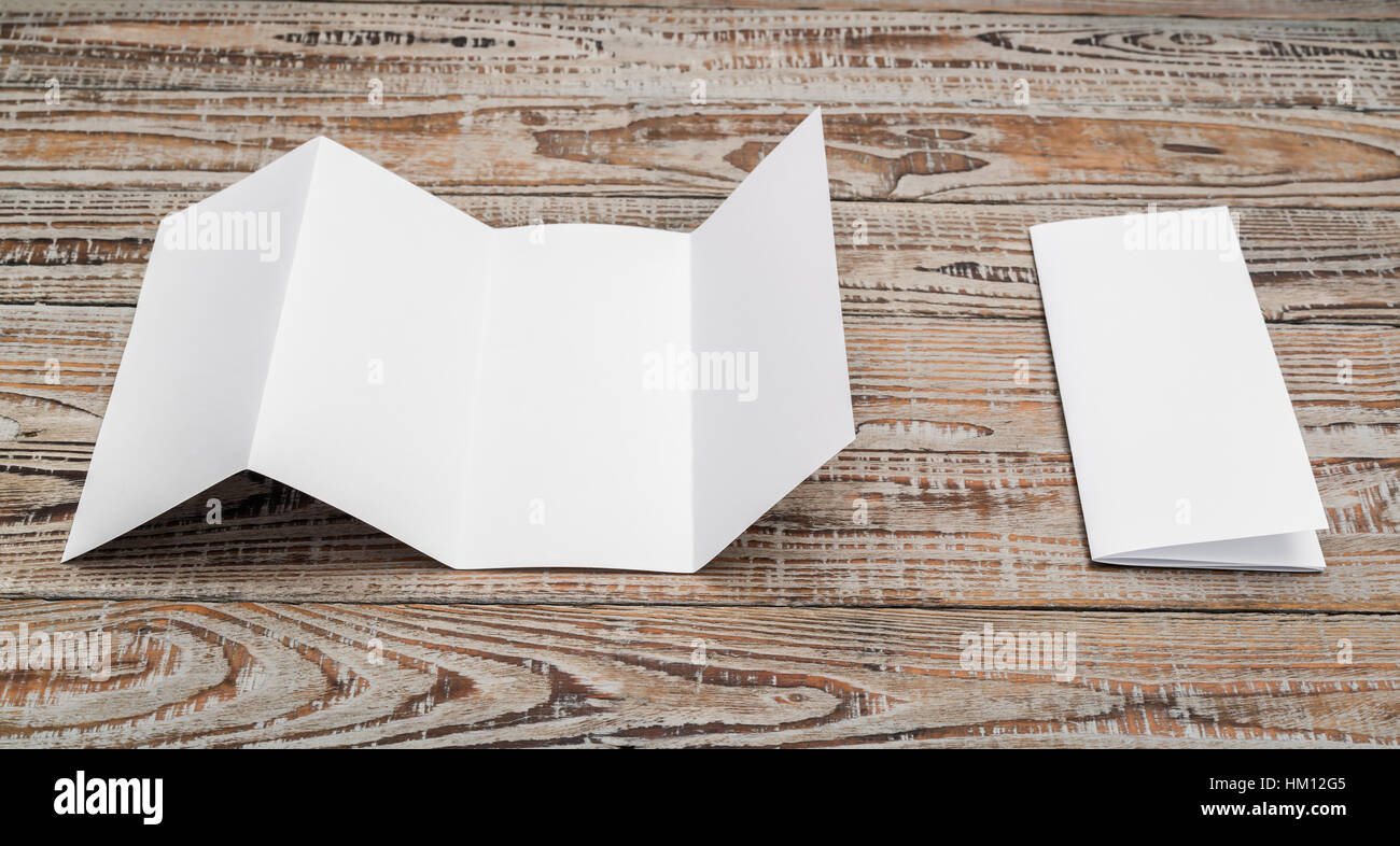 Four - fold white template paper on wood texture Stock Photo - Alamy