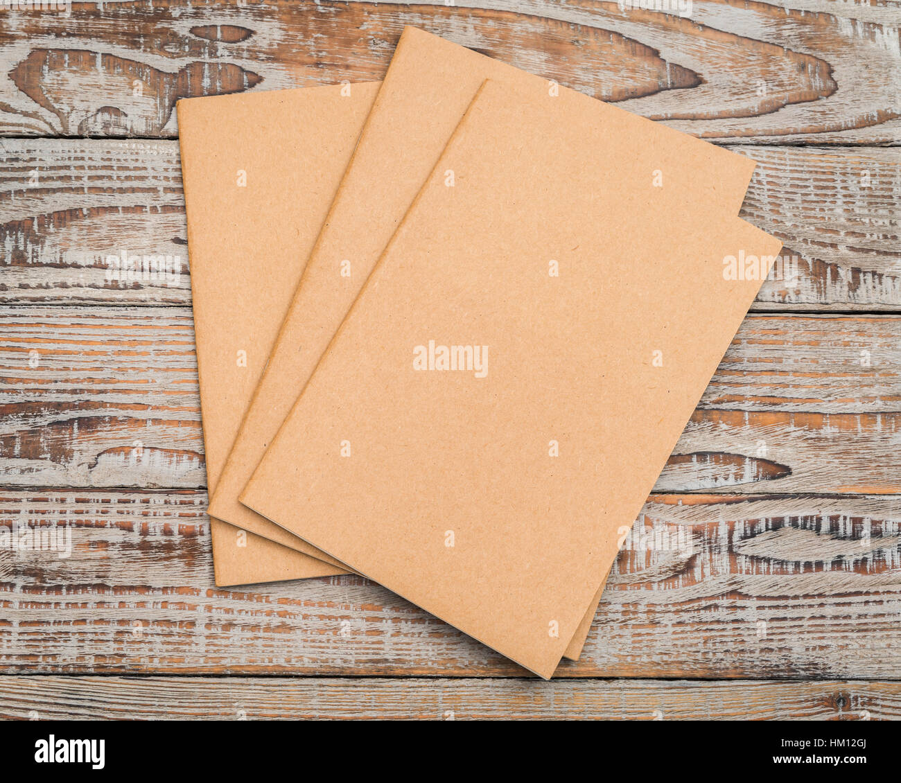 Recycled paper book on wood background Stock Photo - Alamy