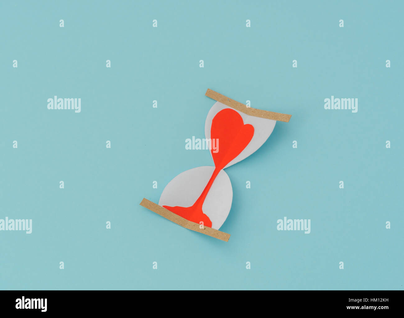 Paper cut of Hearts in Sand Clock Stock Photo - Alamy