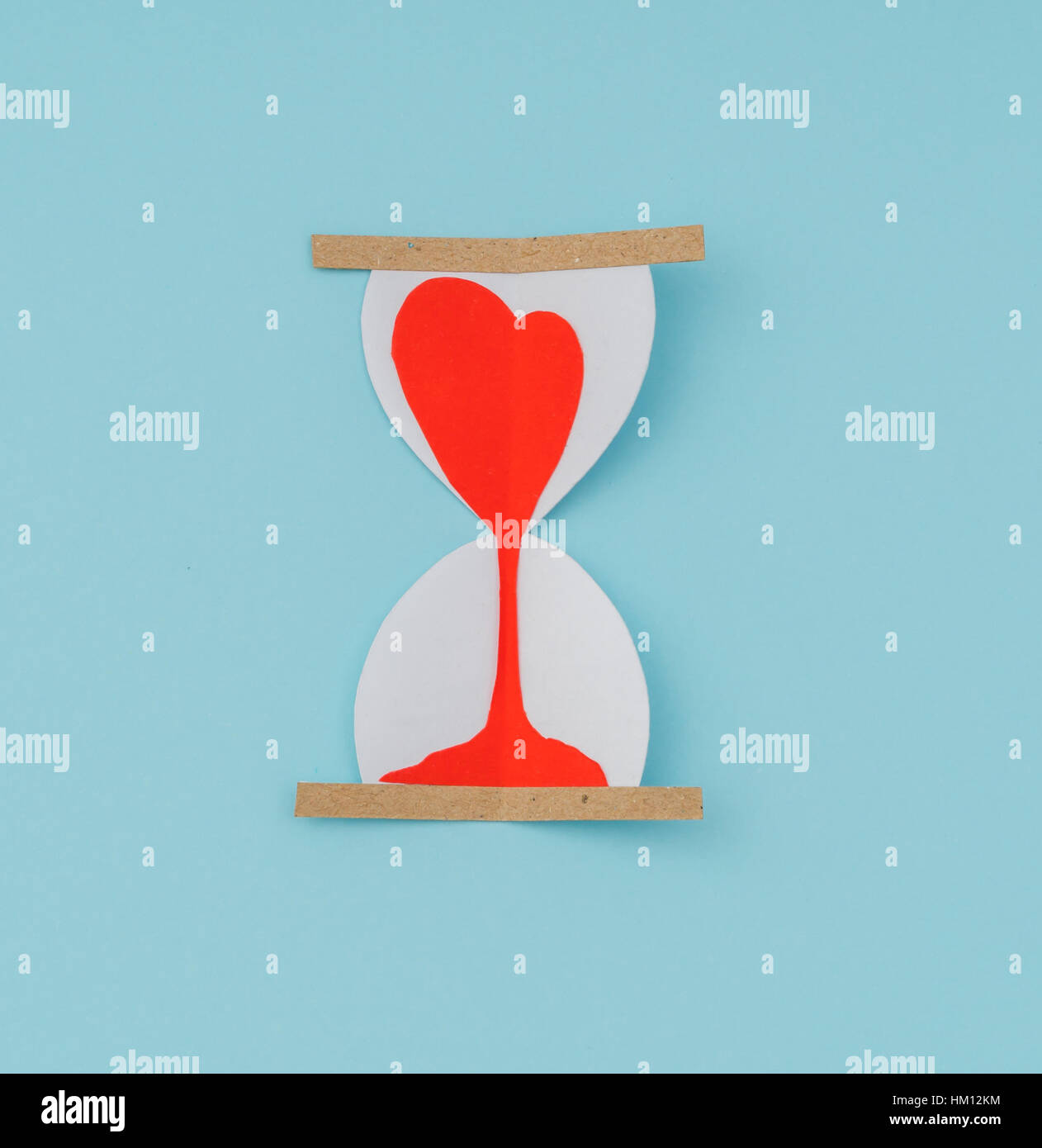 Paper cut of Hearts in Sand Clock Stock Photo - Alamy