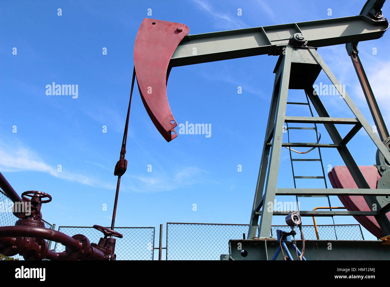 crude oil jack pump under blue sky in europe Stock Photo - Alamy