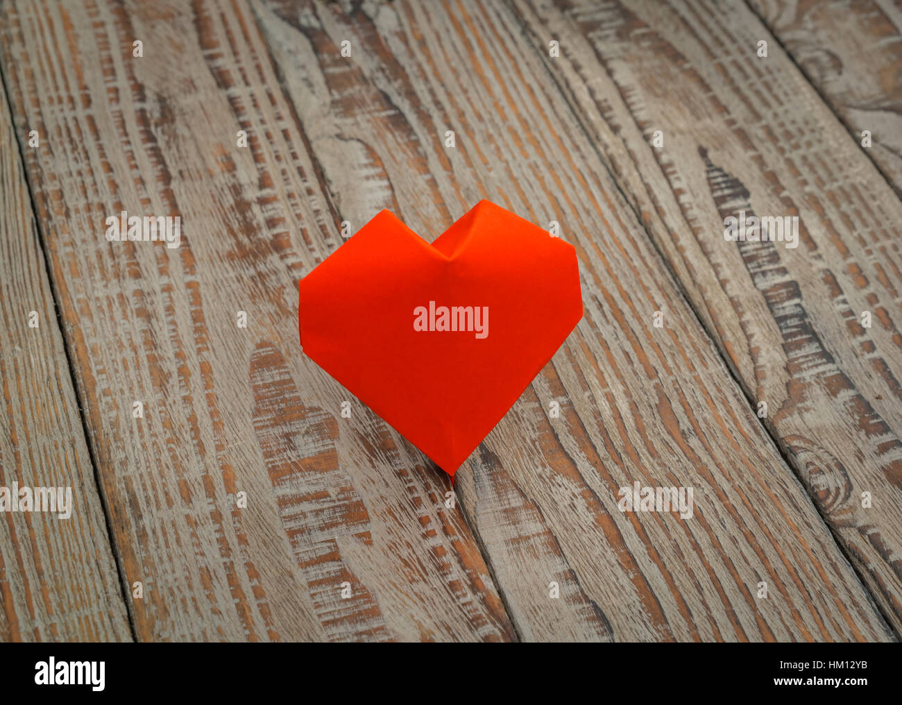 Red paper origami heart on wood background Stock Photo - Alamy