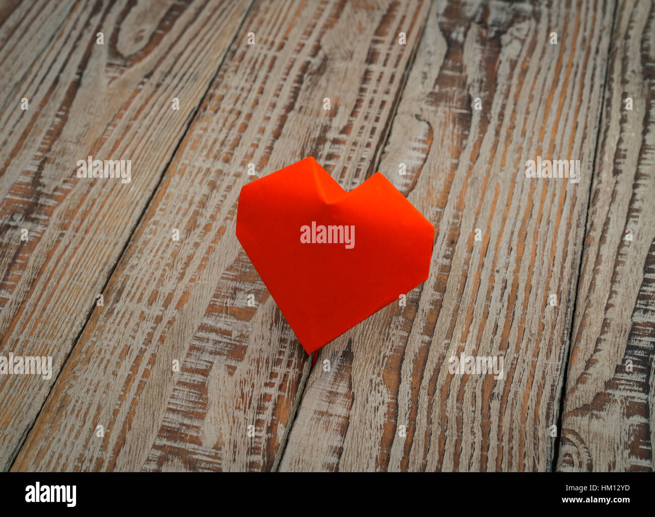 Red paper origami heart on wood background Stock Photo - Alamy