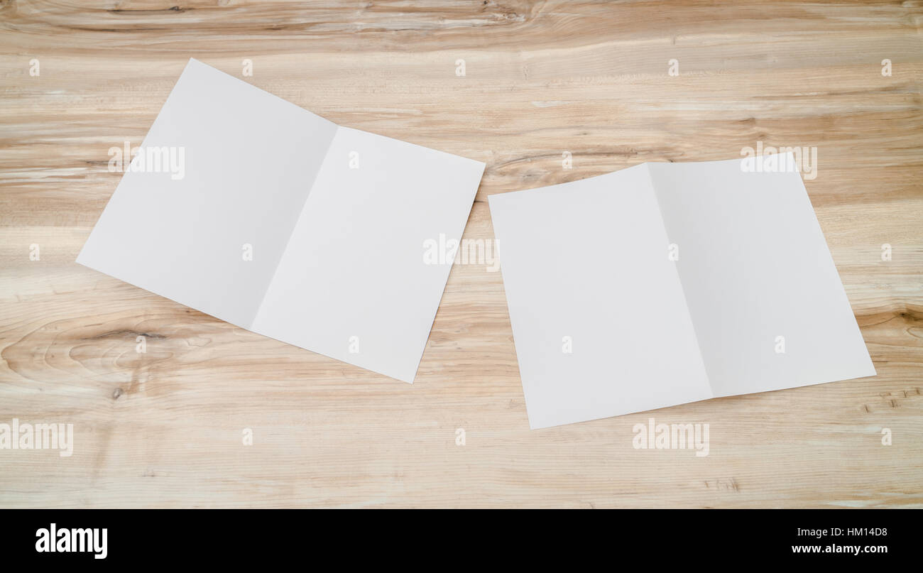 Bifold white template paper on wood texture Stock Photo - Alamy