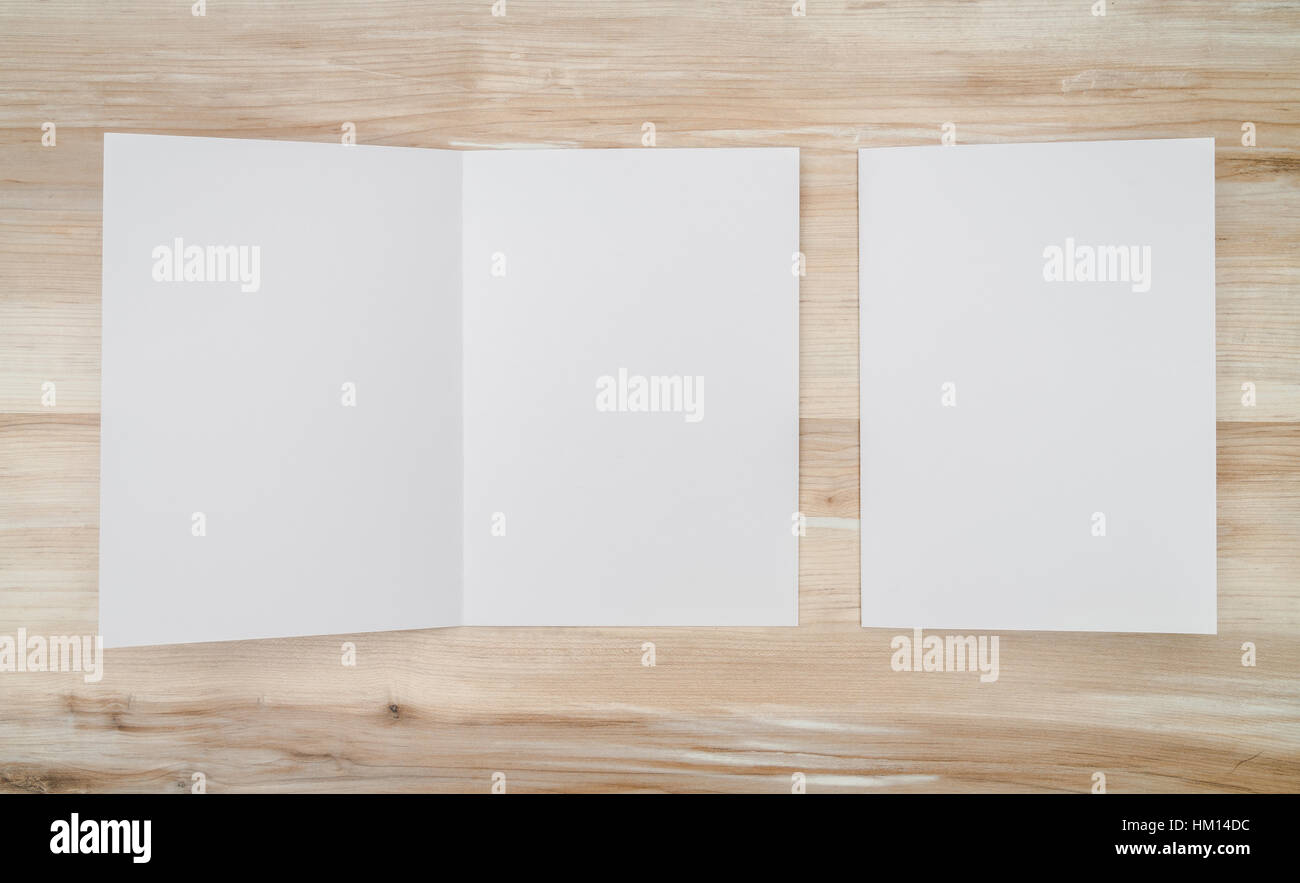 Bifold white template paper on wood texture Stock Photo - Alamy