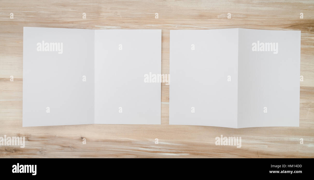 Bifold white template paper on wood texture Stock Photo - Alamy
