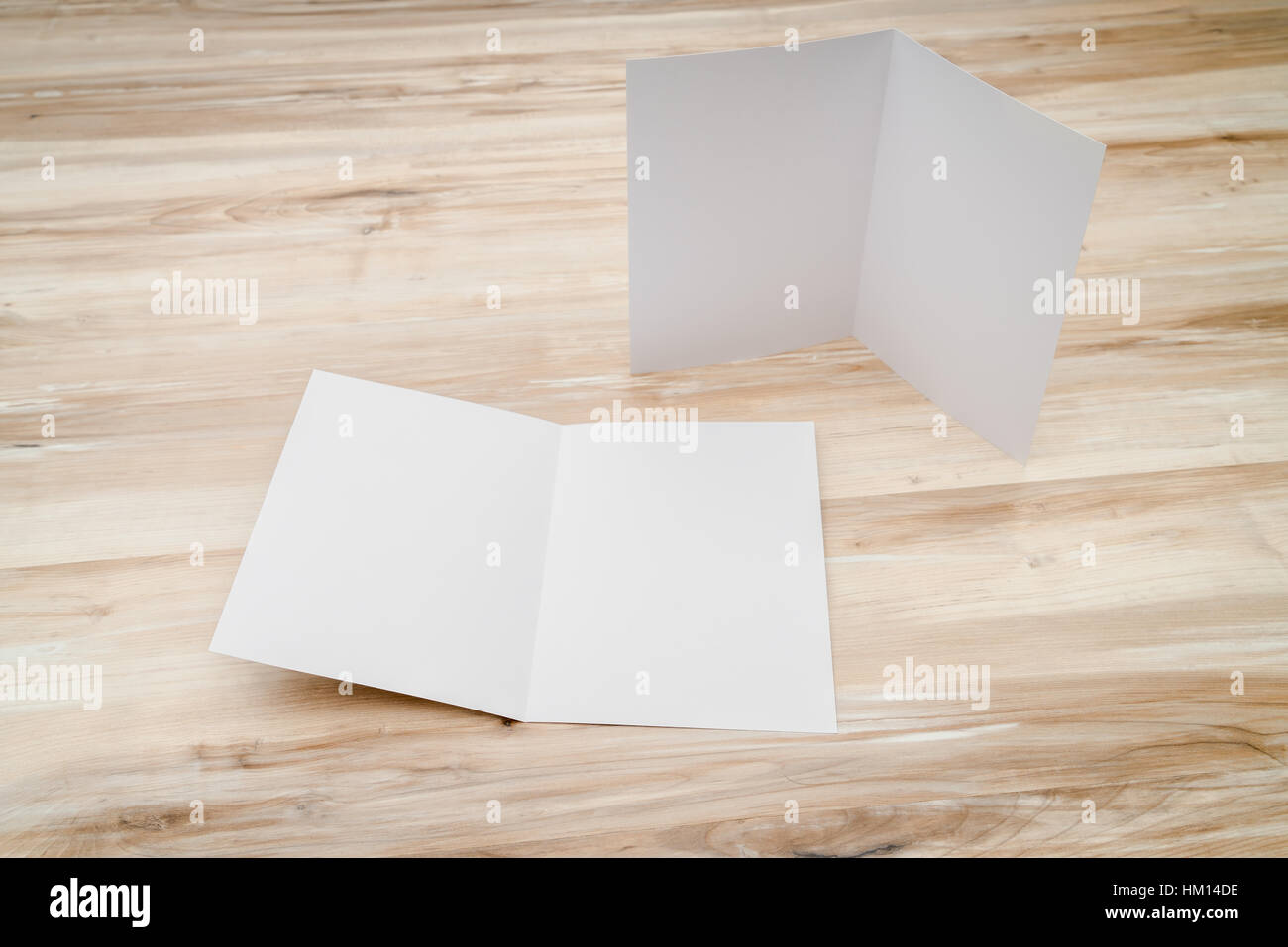 Bifold white template paper on wood texture Stock Photo - Alamy