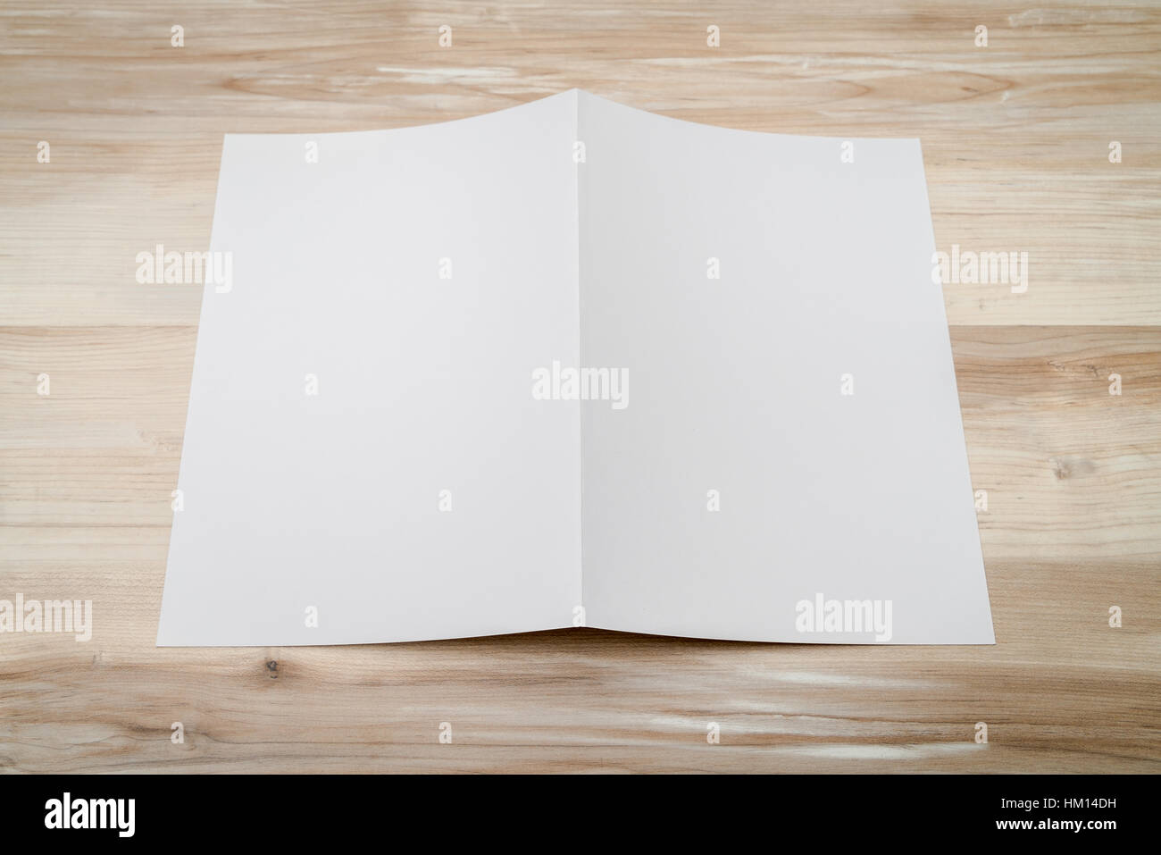 Bifold white template paper on wood texture Stock Photo - Alamy