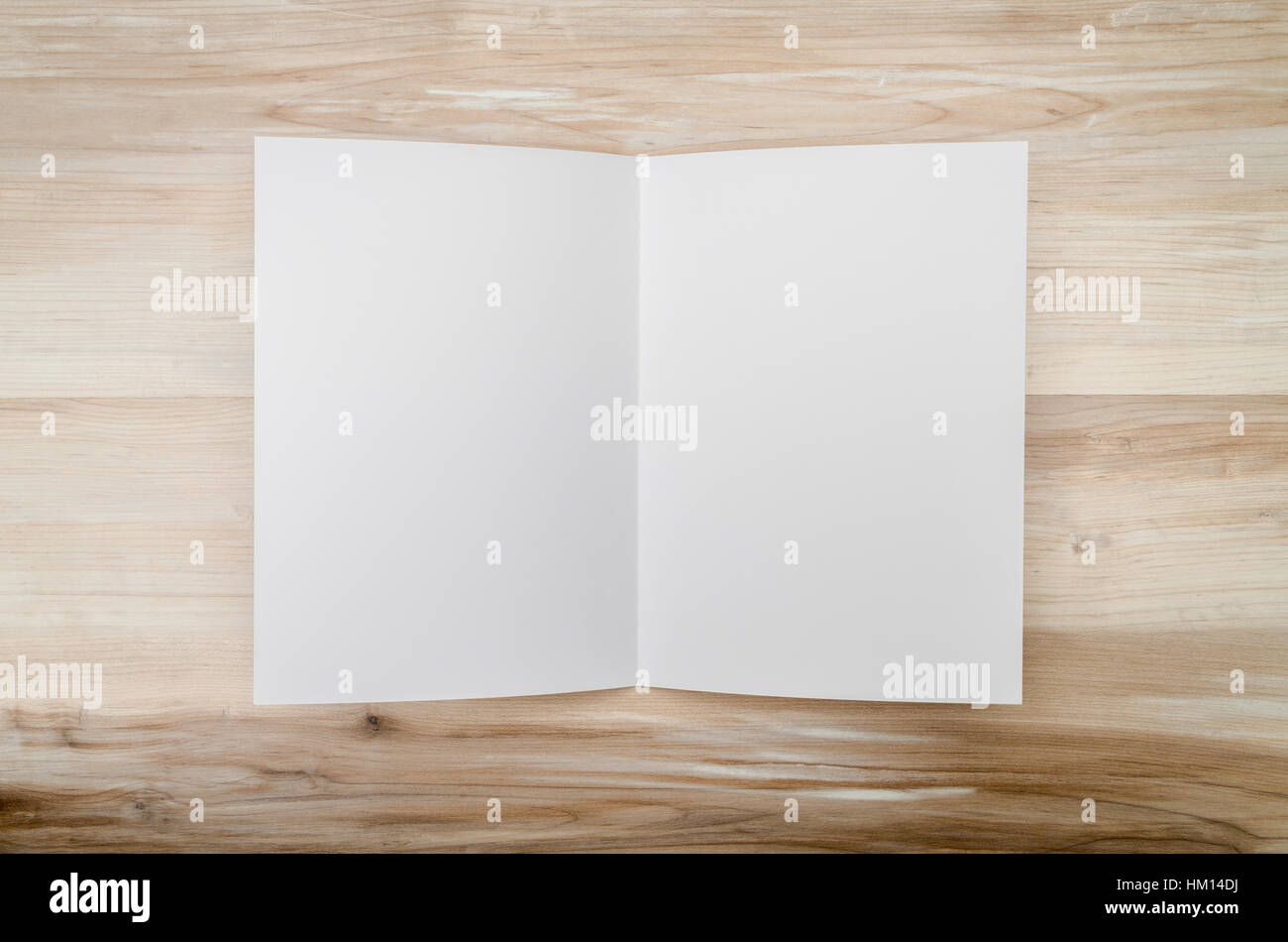 Bifold white template paper on wood texture Stock Photo - Alamy
