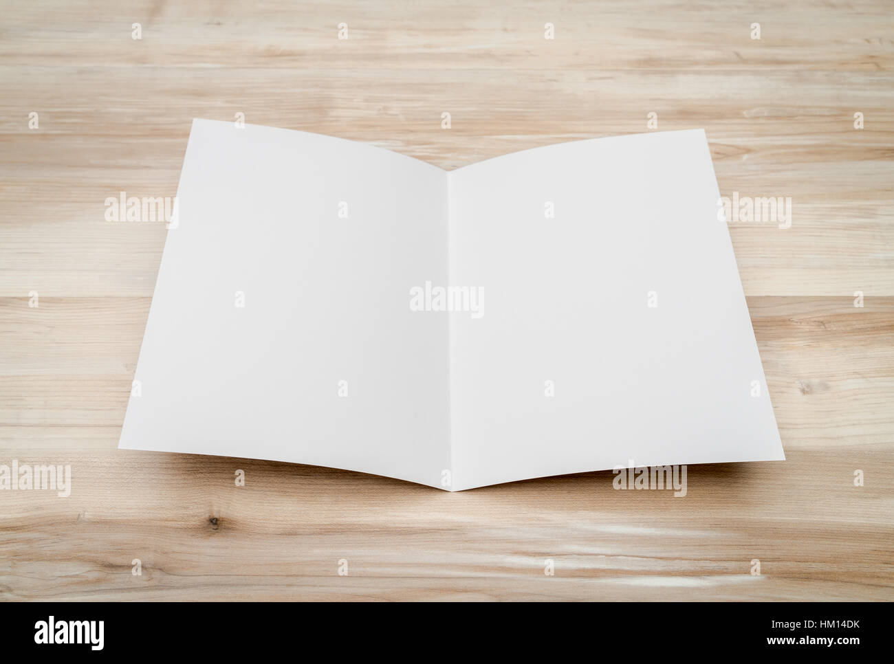 Bifold white template paper on wood texture Stock Photo - Alamy