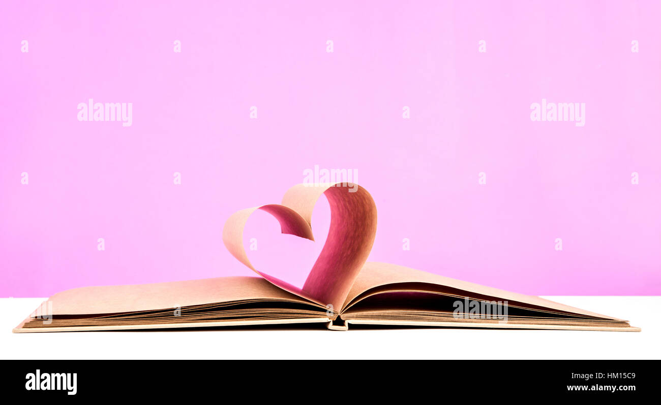 Book with opened pages of shape of heart Stock Photo - Alamy
