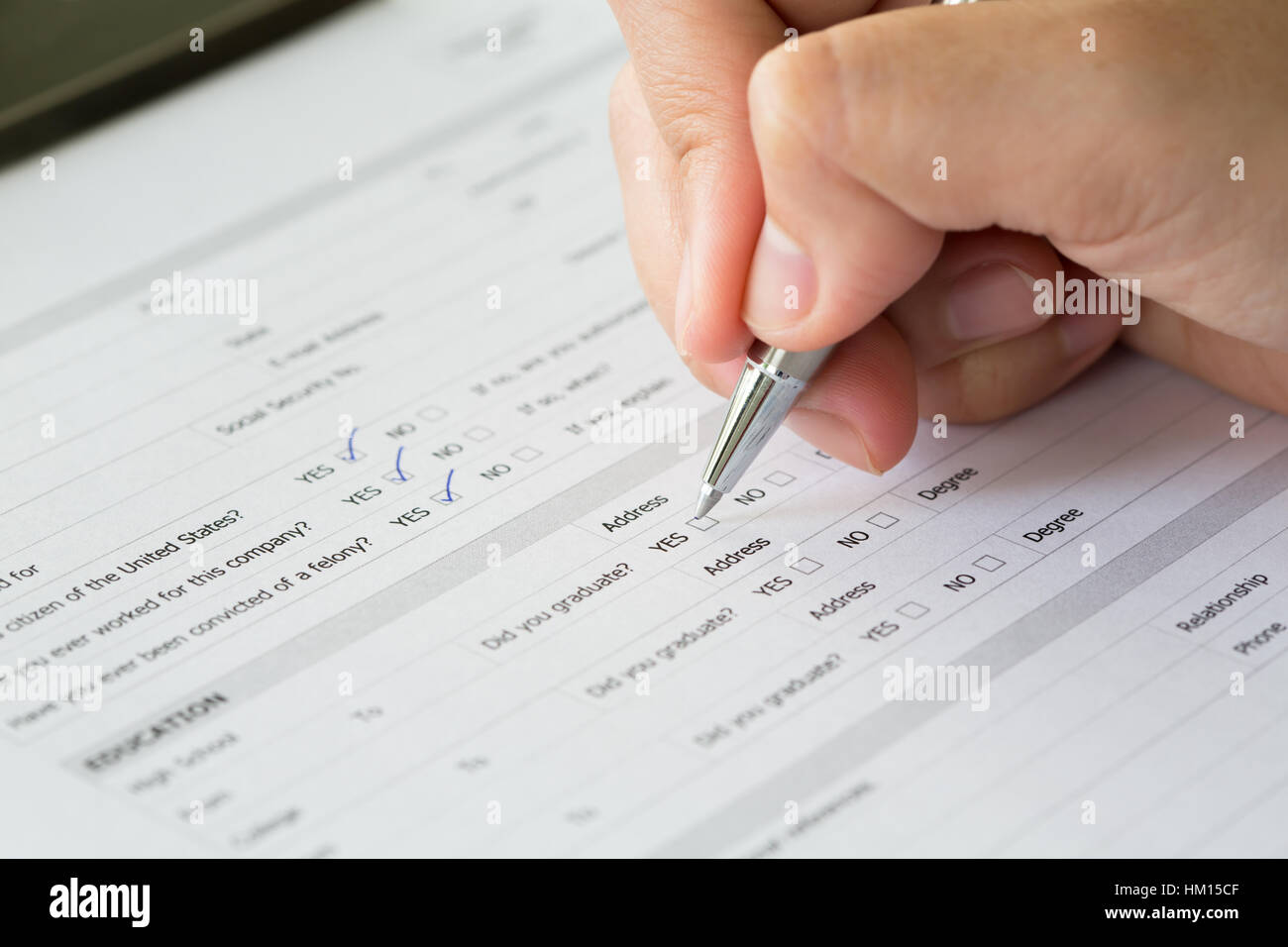 Hand with pen over blank check boxes in application form Stock Photo ...