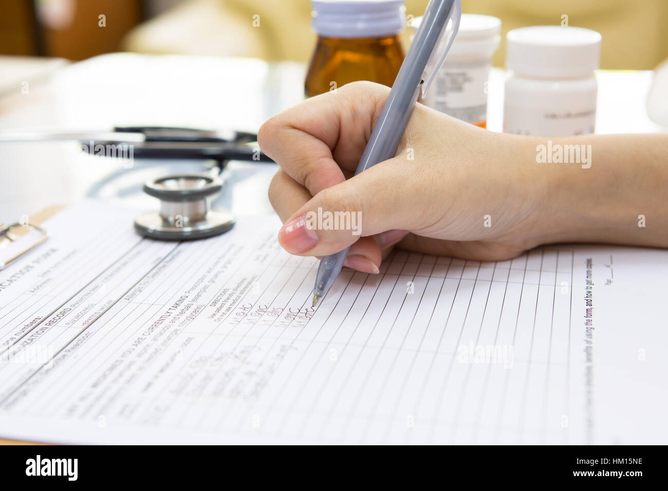 Doctor hand writing a medical recipe Stock Photo - Alamy