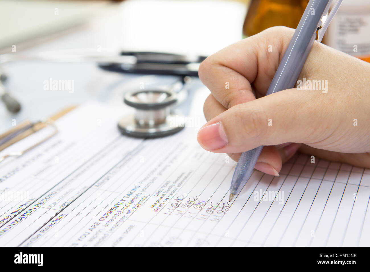 Doctor hand writing a medical recipe Stock Photo - Alamy