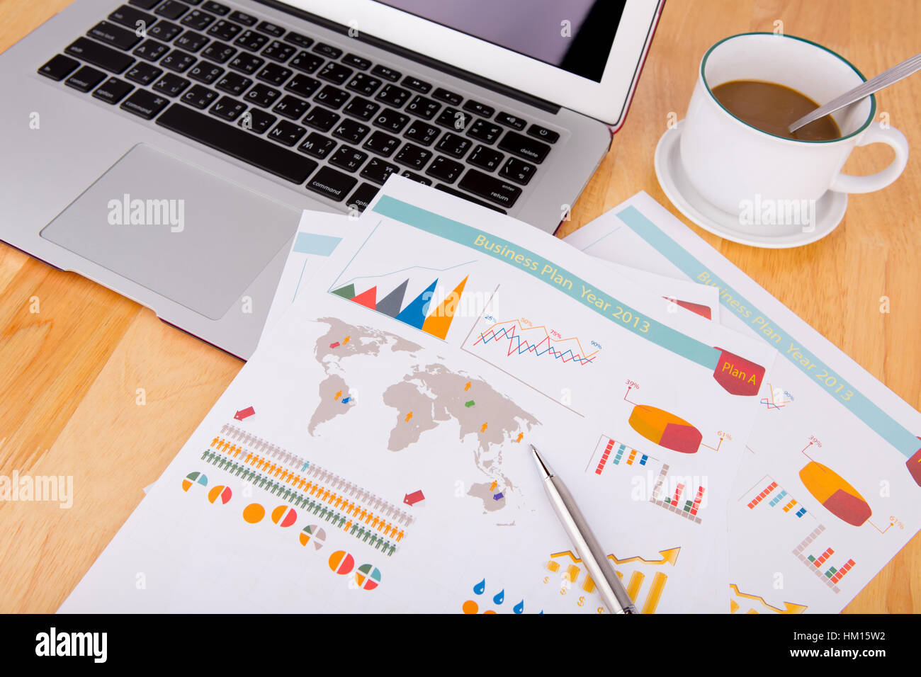 Financial chart on the table with laptop, coffee and pen Stock Photo ...