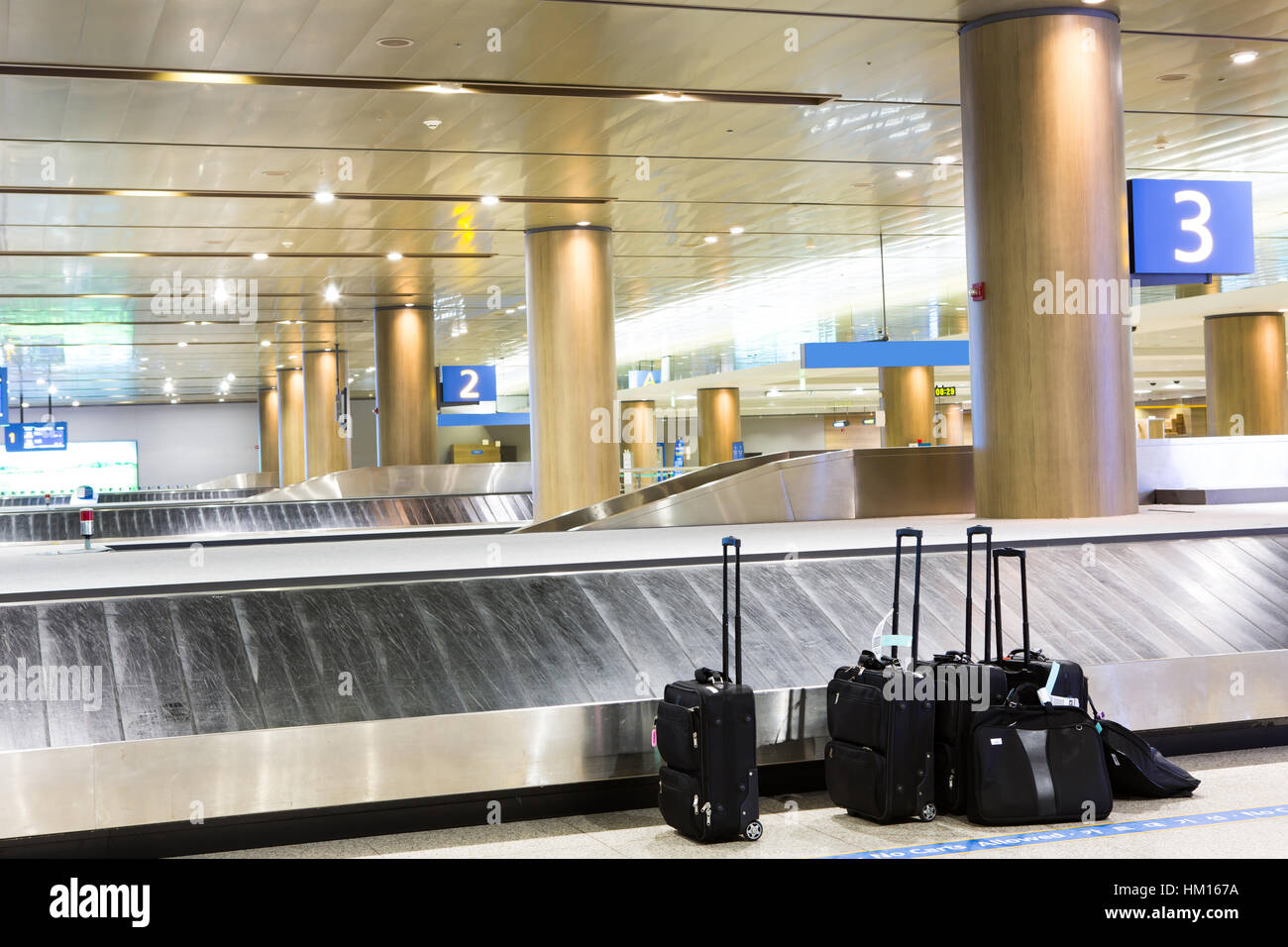 Suitcases at airport interior at baggage claim Stock Photo - Alamy