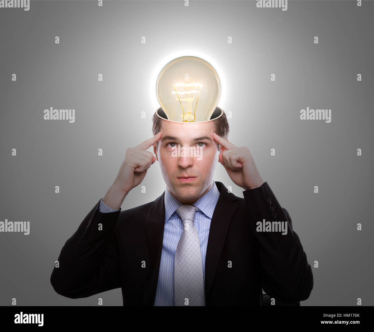 Portrait of young business man thinking with light bulb out from head ...