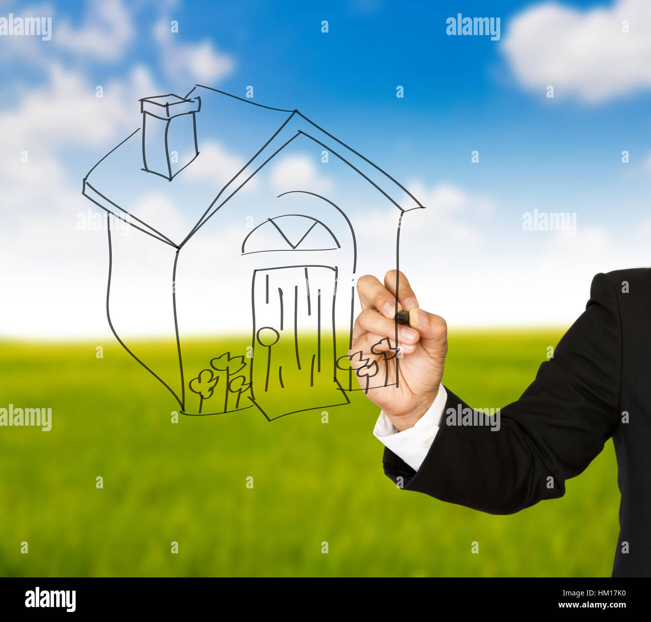 Business hand with pen drawing a house Stock Photo - Alamy