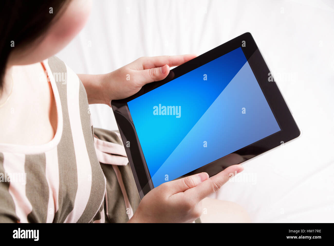 Woman reading the touch screen device Stock Photo - Alamy