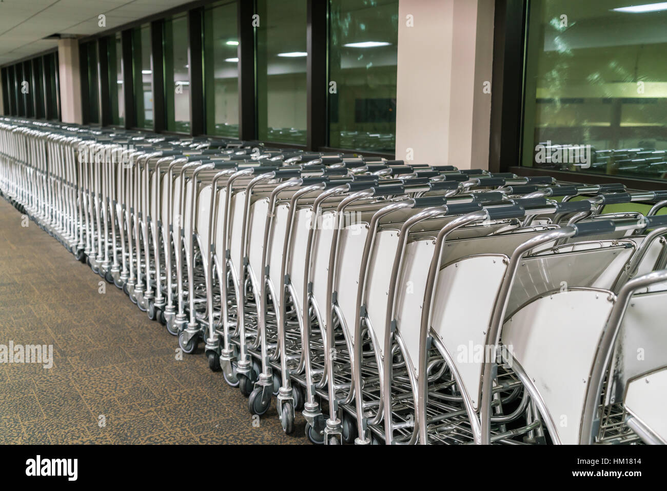 luggage carts at airport terminal Stock Photo - Alamy