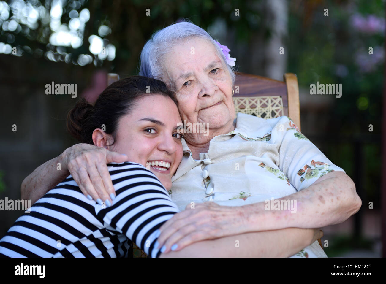 Grandma and grandaughter together hugging and laughing Stock Photo - Alamy