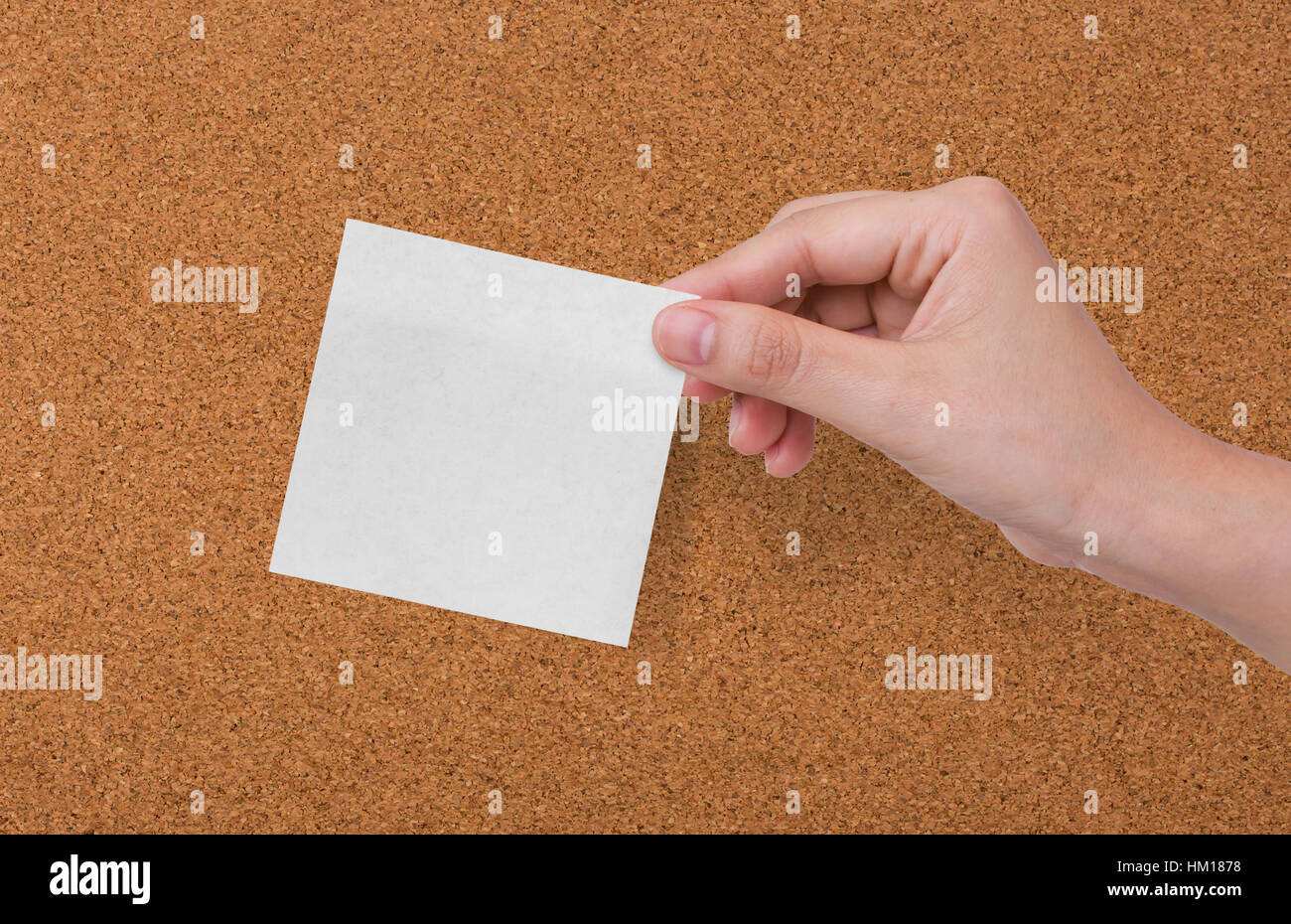 Post-it note with hand on cork board Stock Photo - Alamy