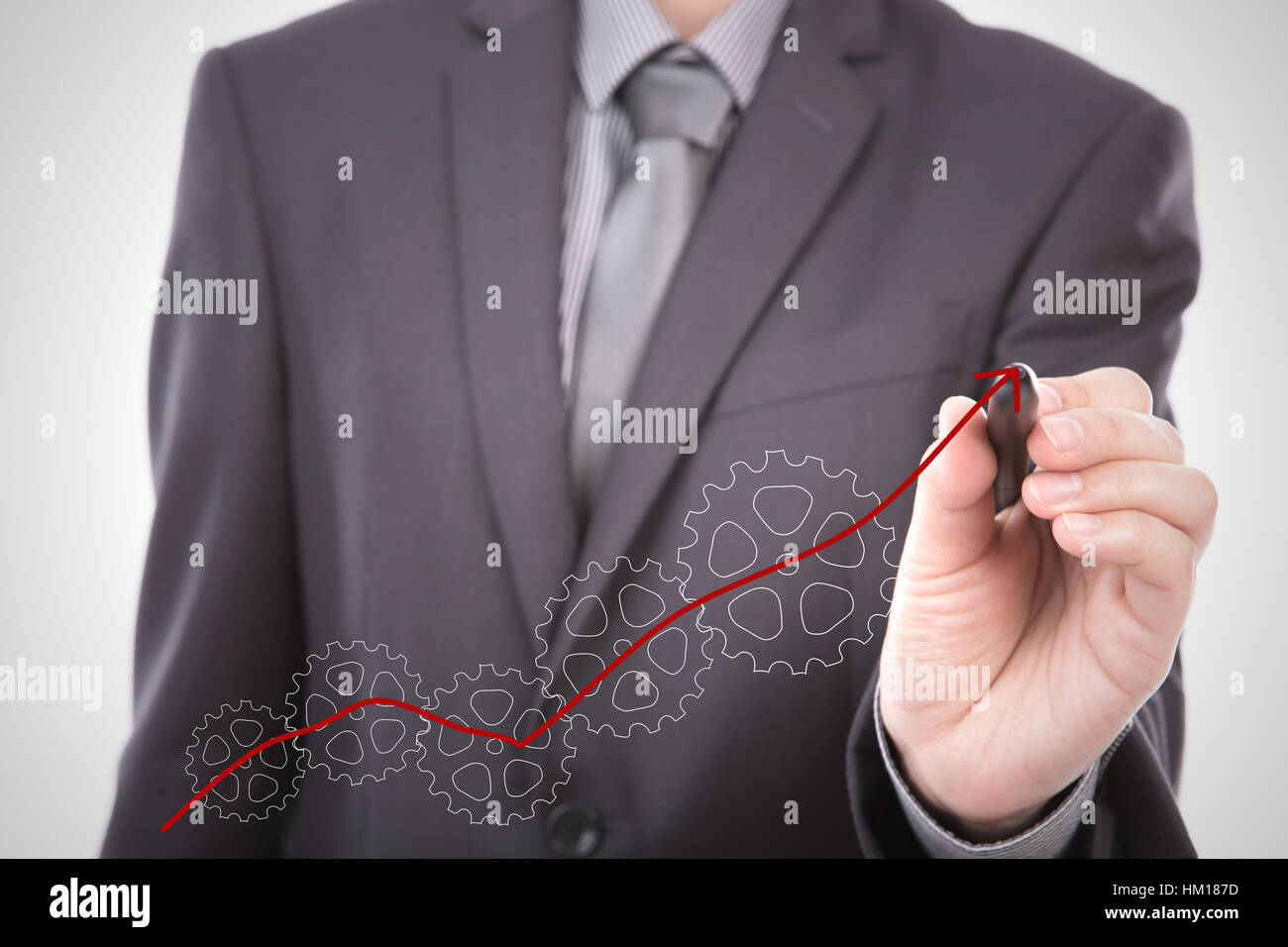 Businessman hand drawing gear to success concept Stock Photo - Alamy