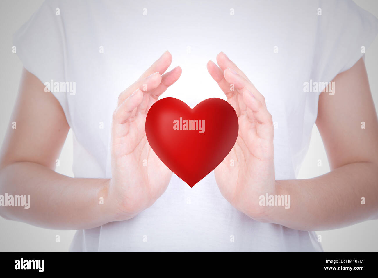 Heart on woman hands over body Stock Photo - Alamy