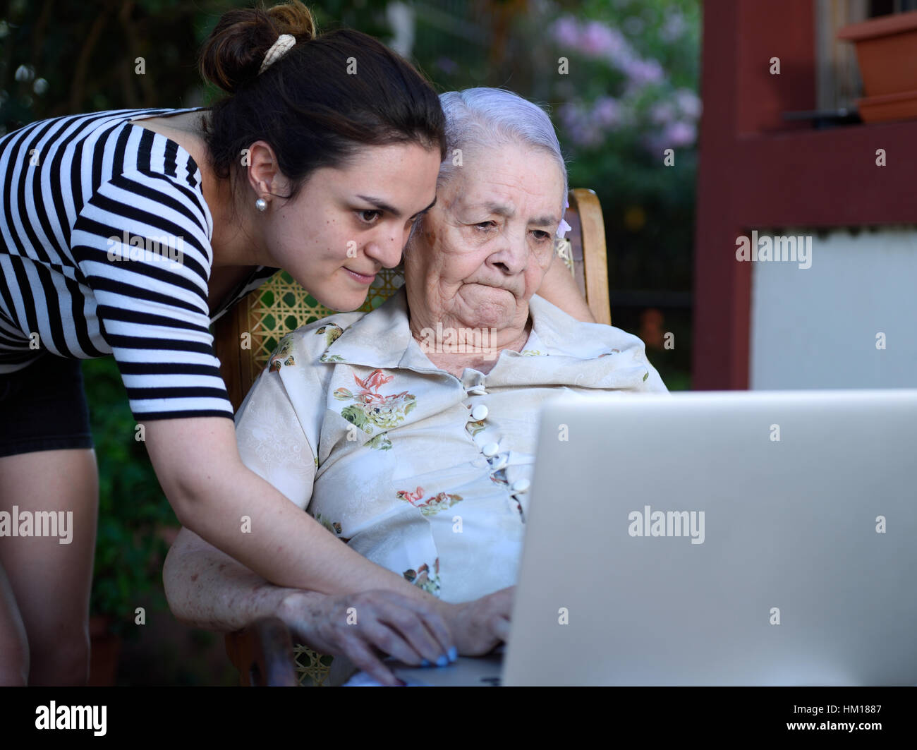 girl and grandma look into modern laptop Stock Photo - Alamy
