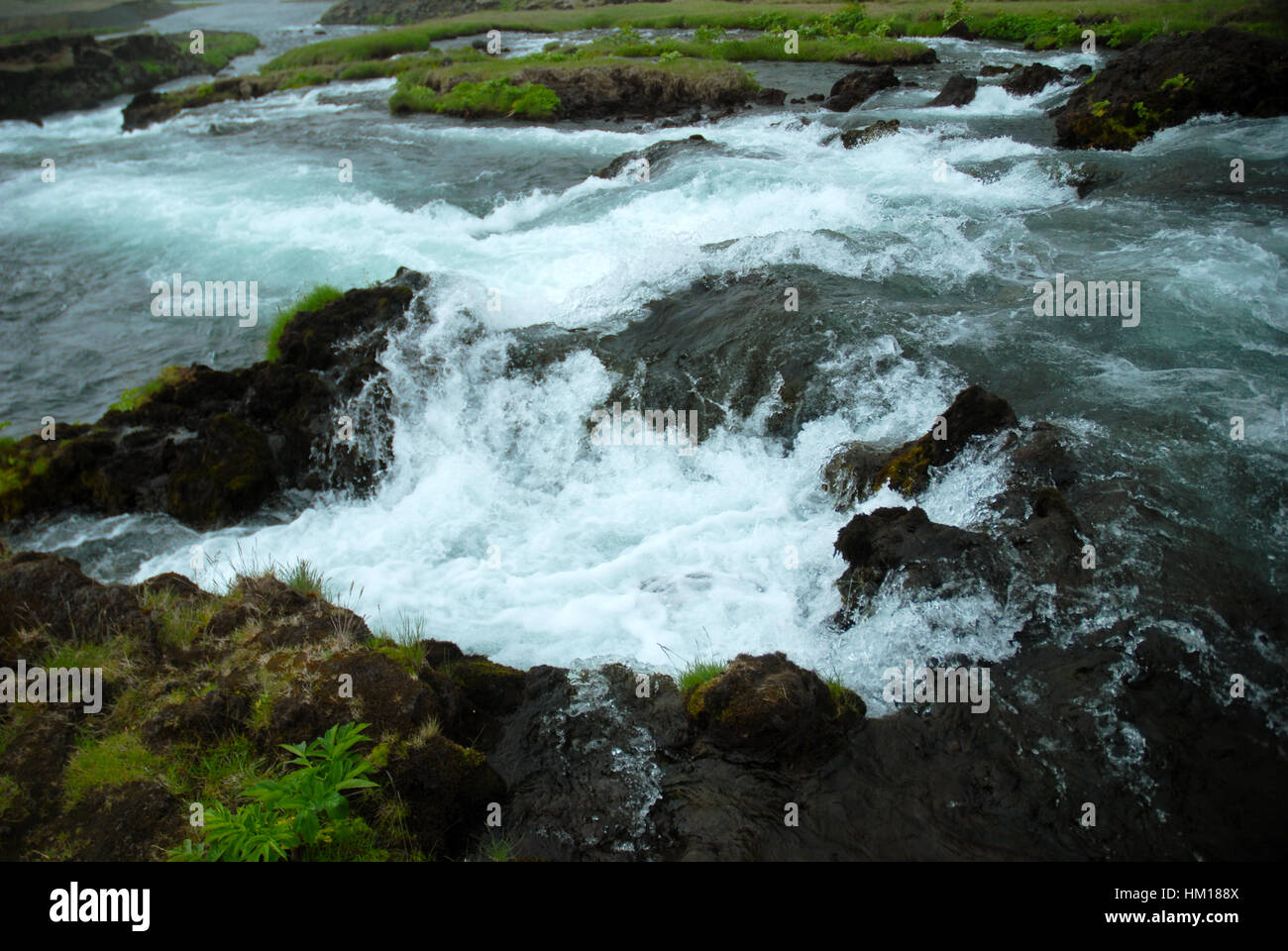 Fast moving stream and rapids of cold glacial water, Iceland Stock ...