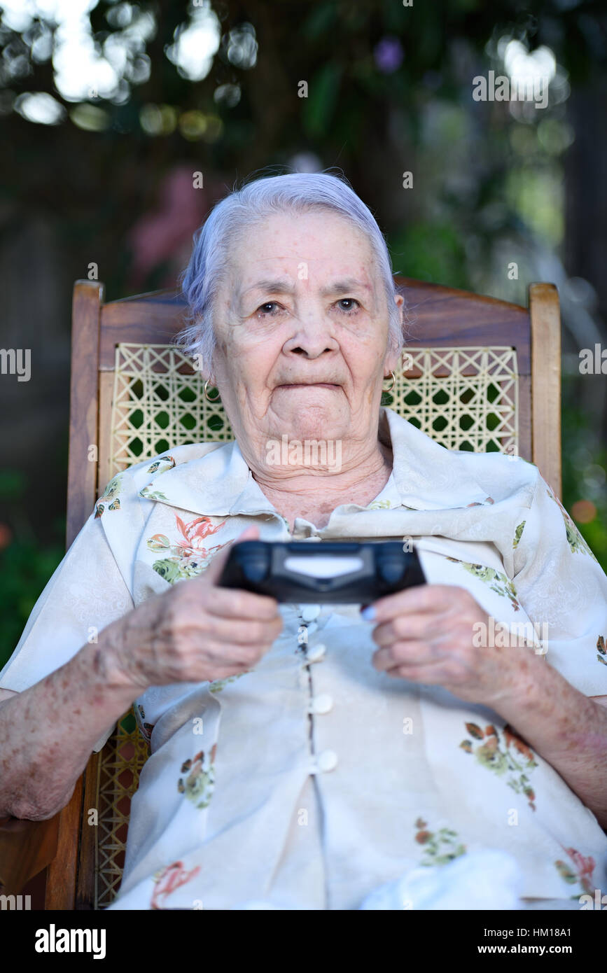grandma holding joystick and playing games outside Stock Photo - Alamy
