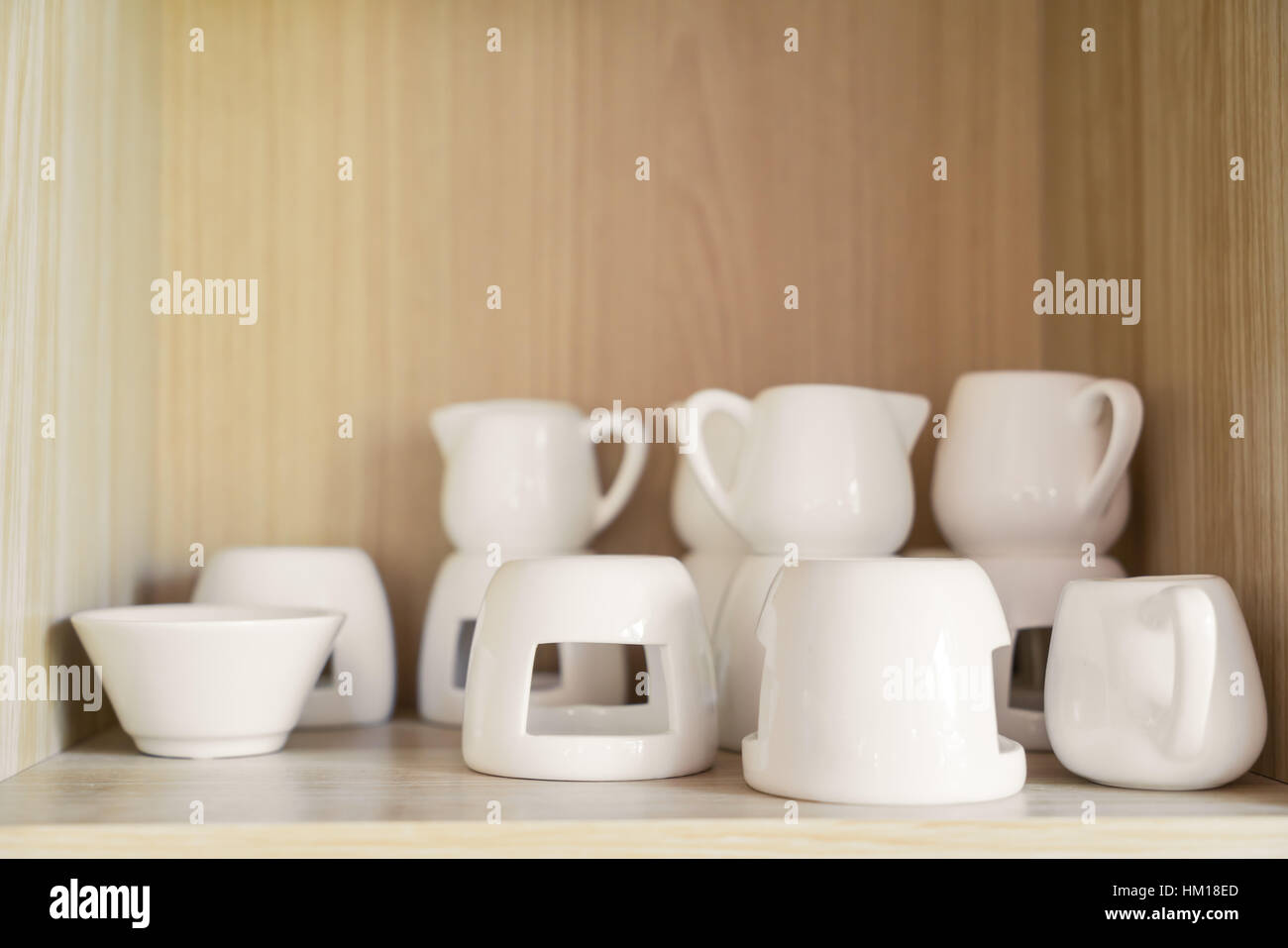 White cups on the shelf Stock Photo - Alamy