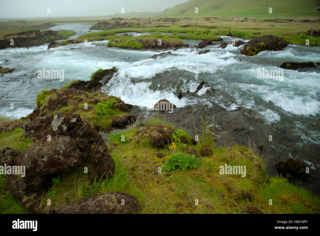 Fast moving stream and rapids of cold glacial water, Iceland Stock ...