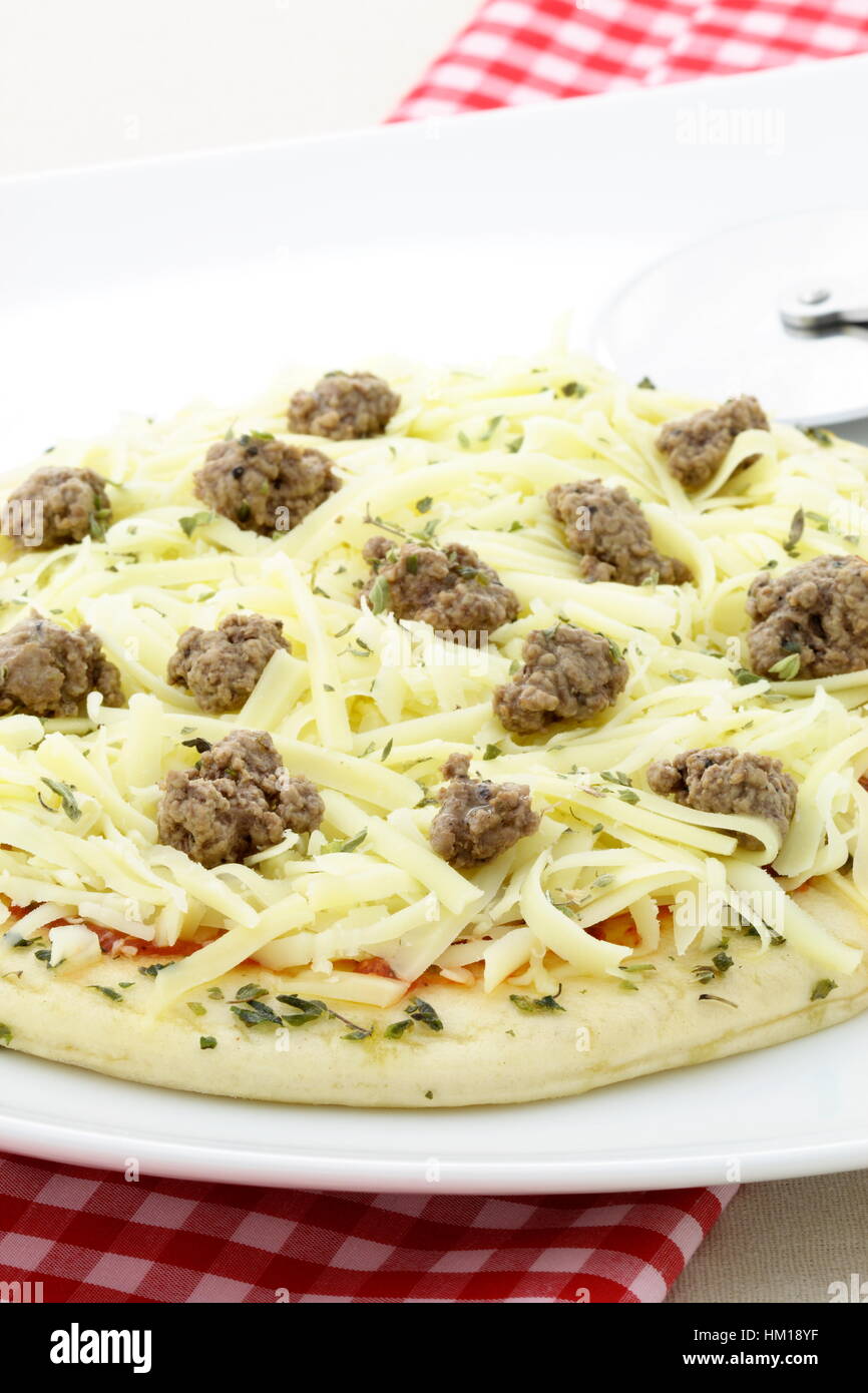 raw meat pizza made with fresh mozzarella cheese and ground beef Stock ...
