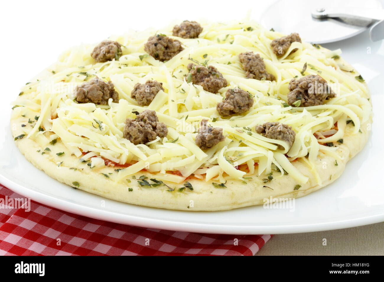 raw meat pizza made with fresh mozzarella cheese and ground beef Stock ...