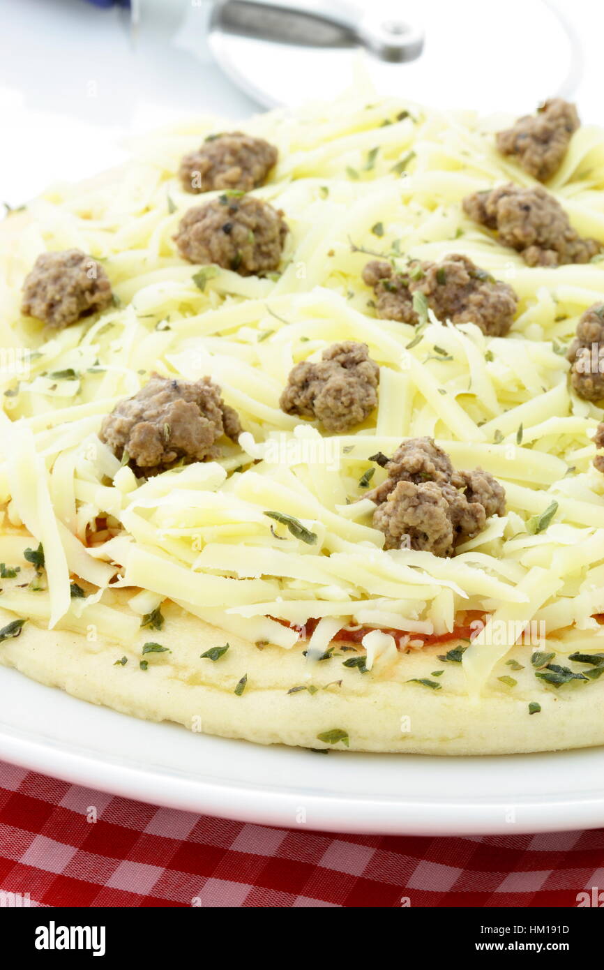 raw meat pizza made with fresh mozzarella cheese and ground beef Stock ...
