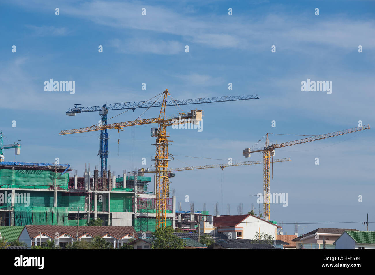 Industrial construction crane with blue sky background Stock Photo - Alamy