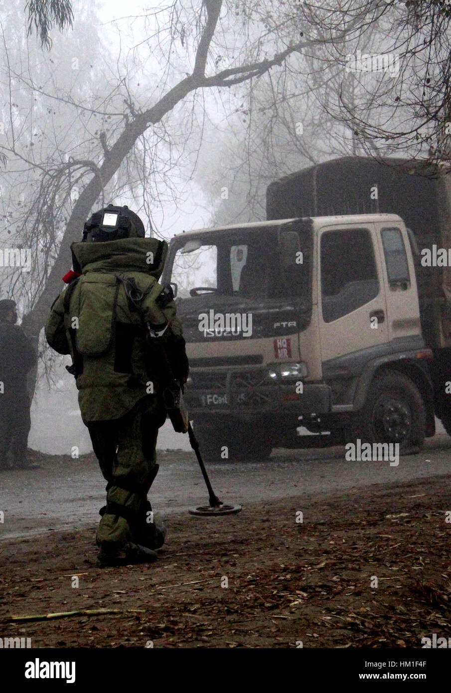 Peshawar. 31st Jan, 2017. A bomb disposal squad member examines at the ...
