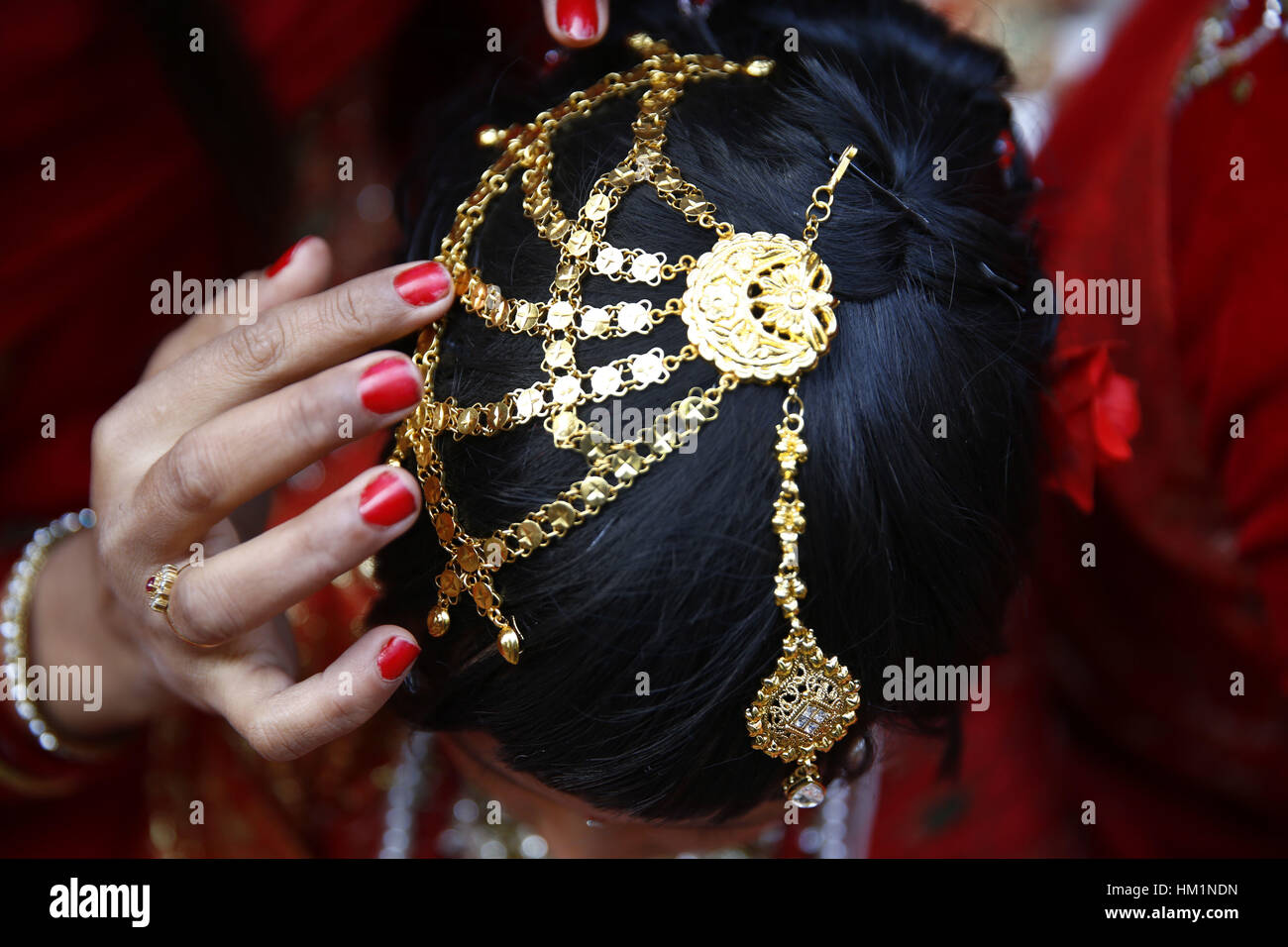 Kathmandu, Nepal. 1st Feb, 2017. A mother arranges jewelry of her ...